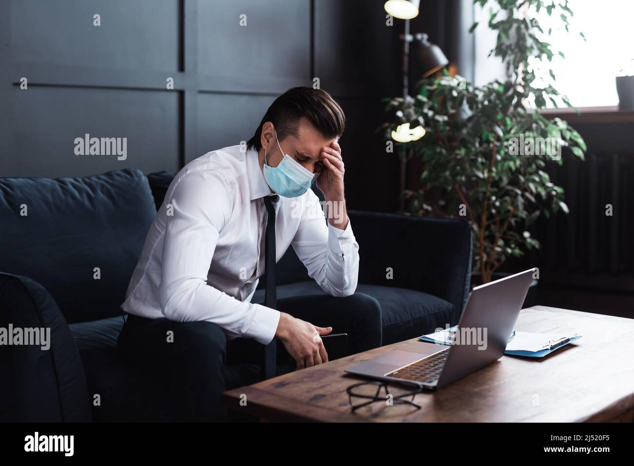 Tired businessman wearing medical protective hi-res stock photography ...