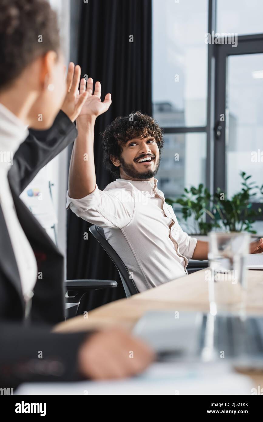 Positive indian businessman giving high five to african american ...