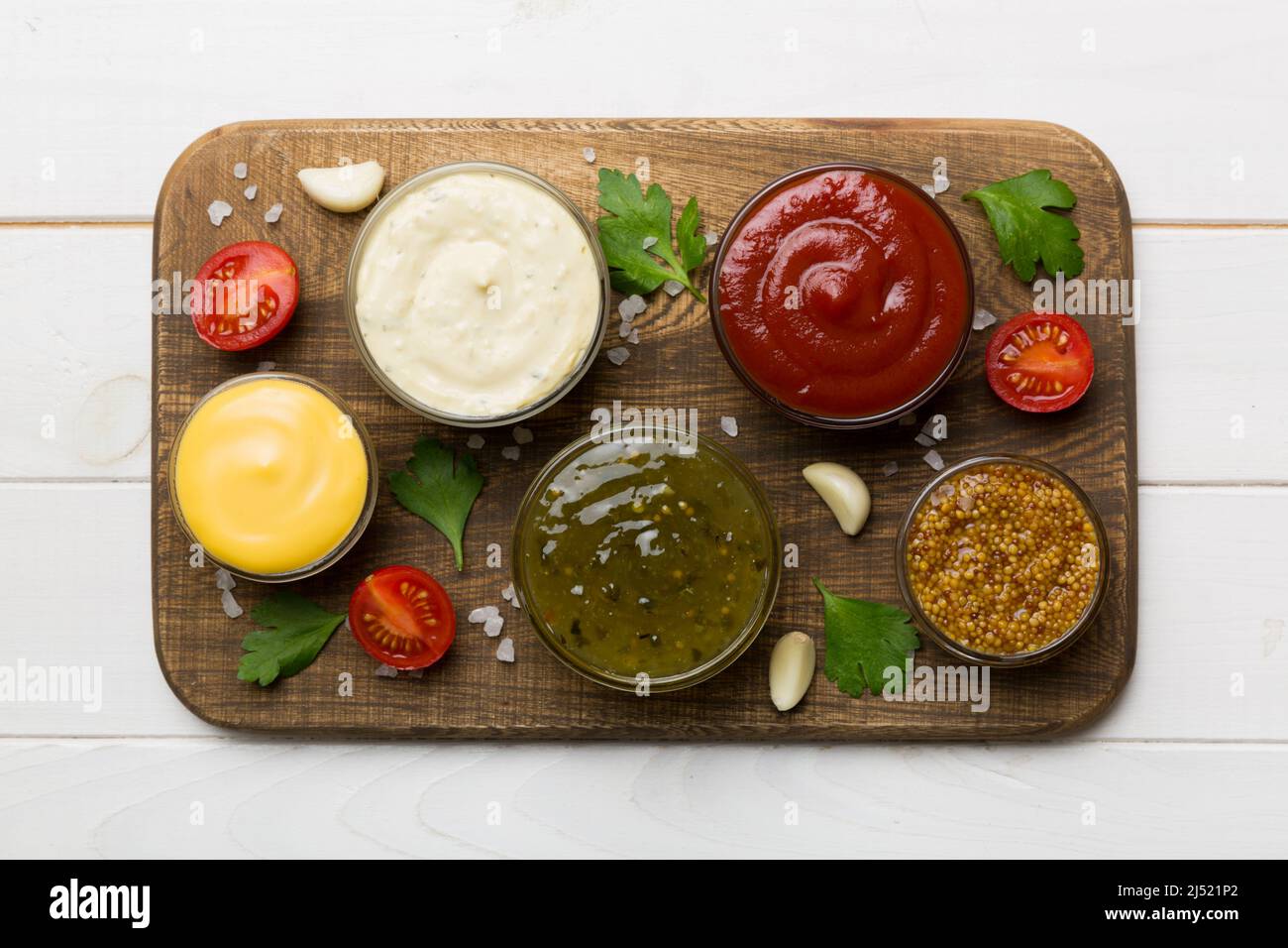 Many different sauces and herbs on table, flat lay top view. sauces on ...