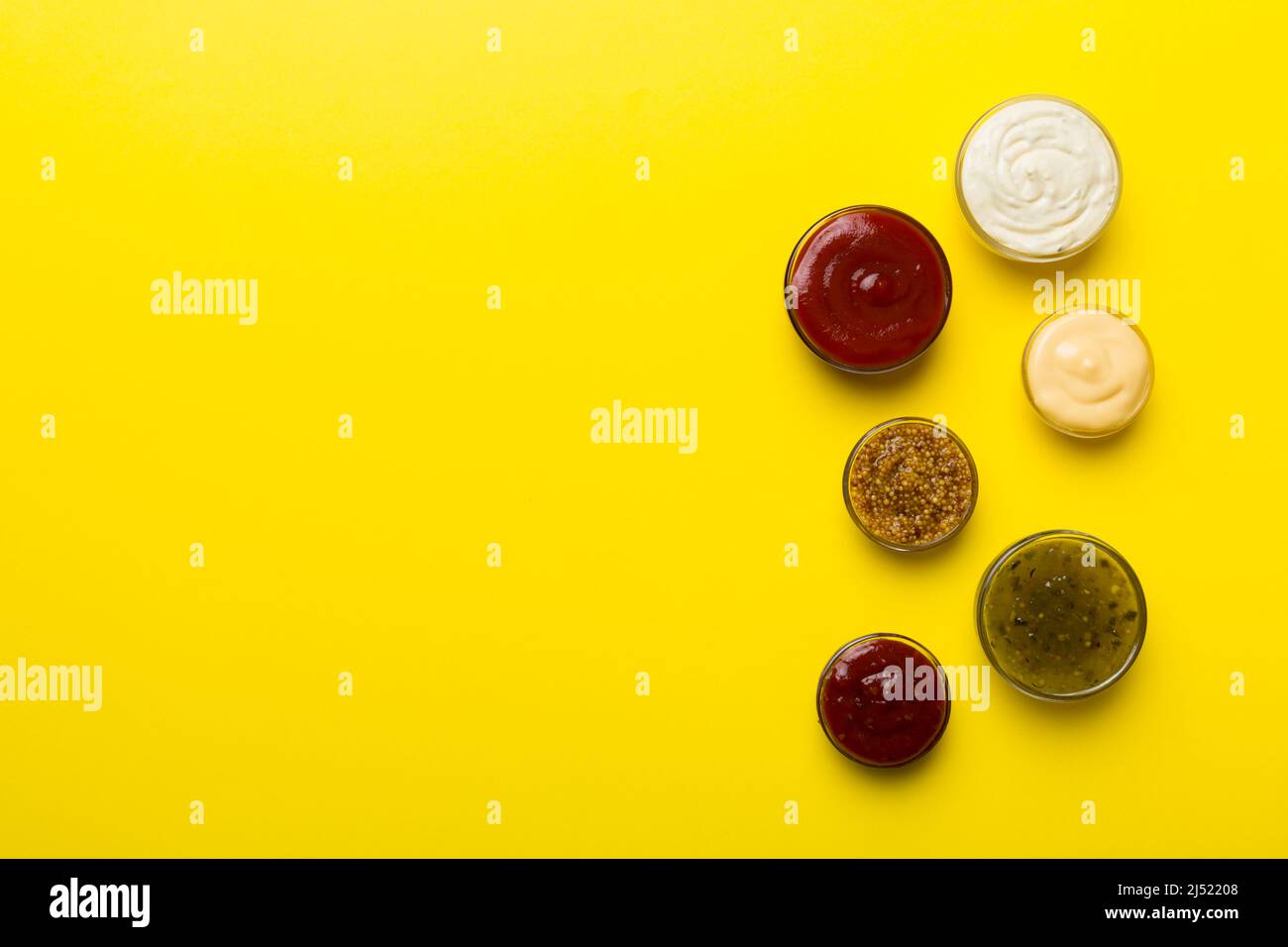 Different types of sauces in bowls on a colored Board . Top view ...