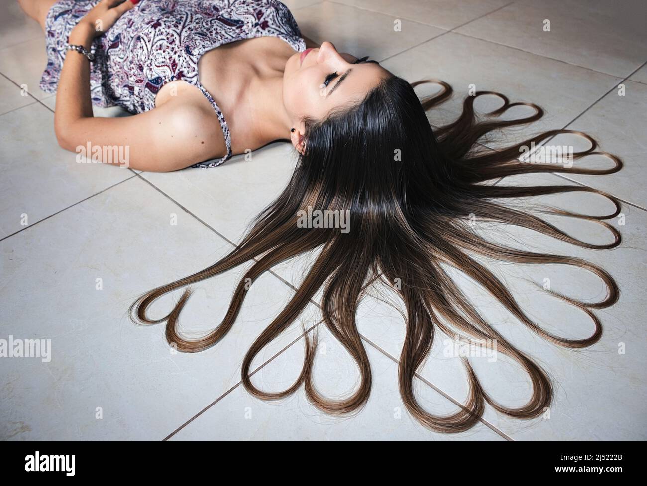 Girl lying on the floor with heart shaped hair Stock Photo - Alamy