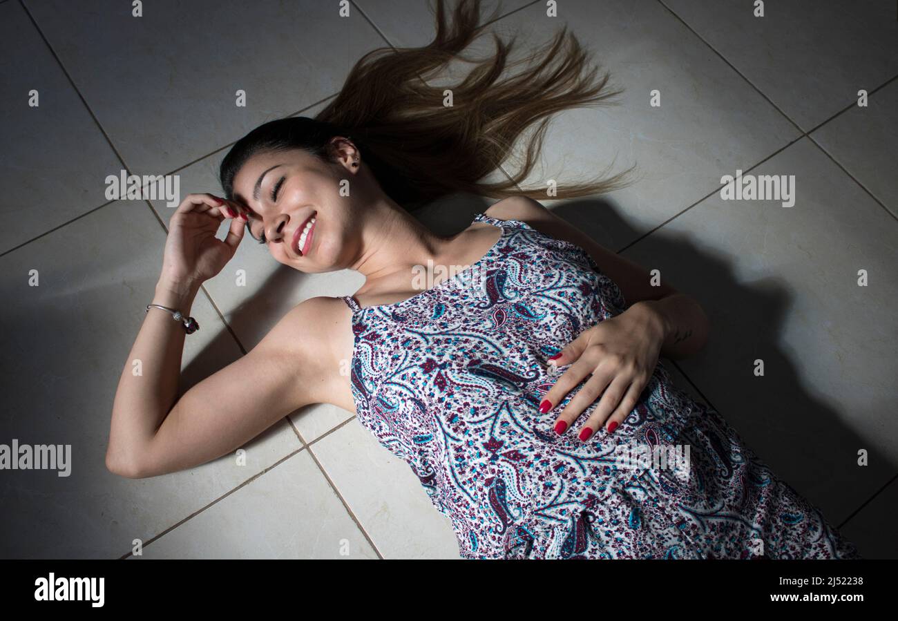 Girl lying on the floor with heart shaped hair Stock Photo - Alamy