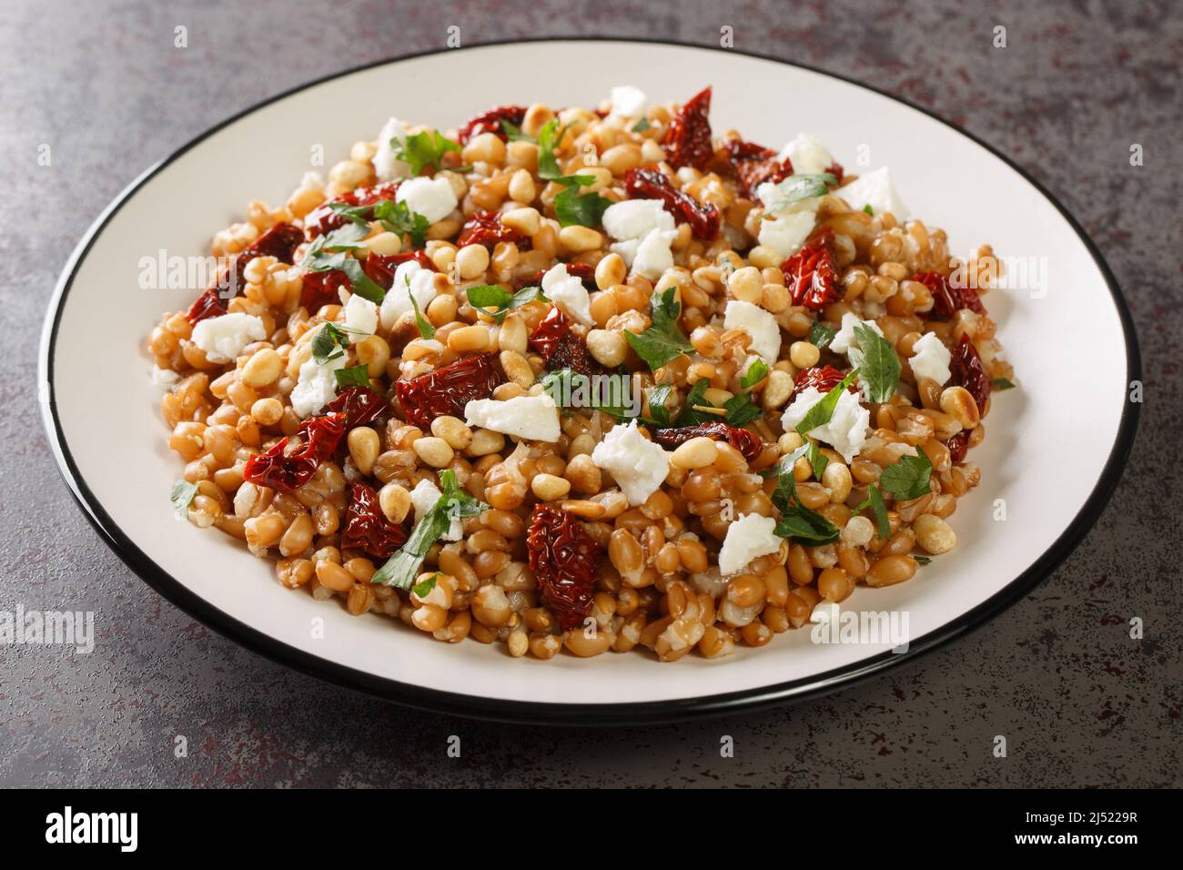Cooked whole grain cereal spelt as salad with vegetables and feta ...