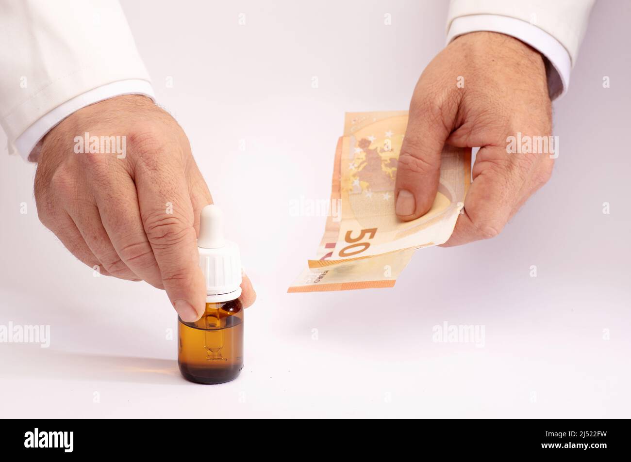 Two hands with oil cannabis and money. The concept of selling marijuana ...