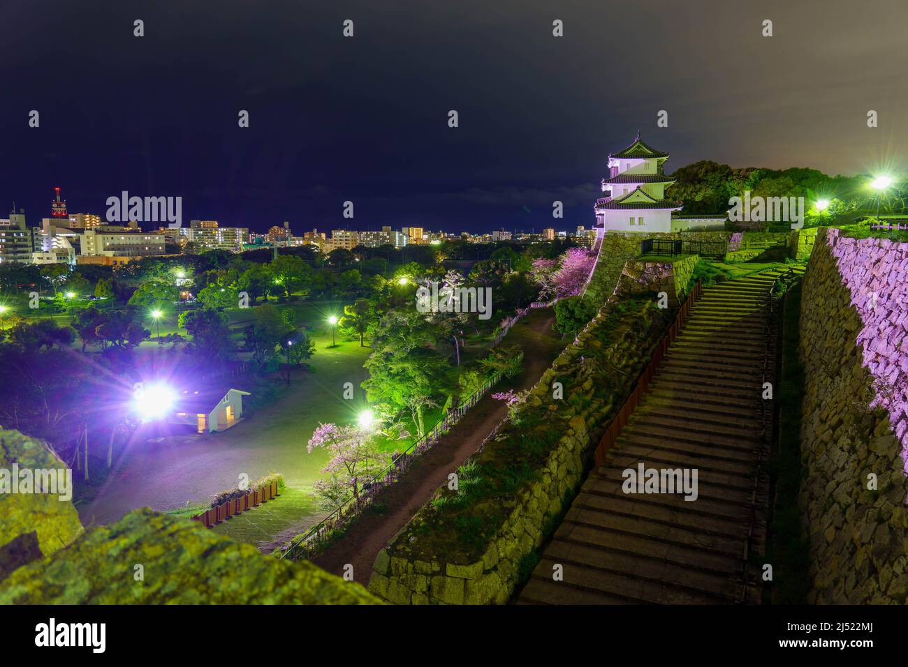 Historic castle atop stone wall overlooking city Stock Photo - Alamy