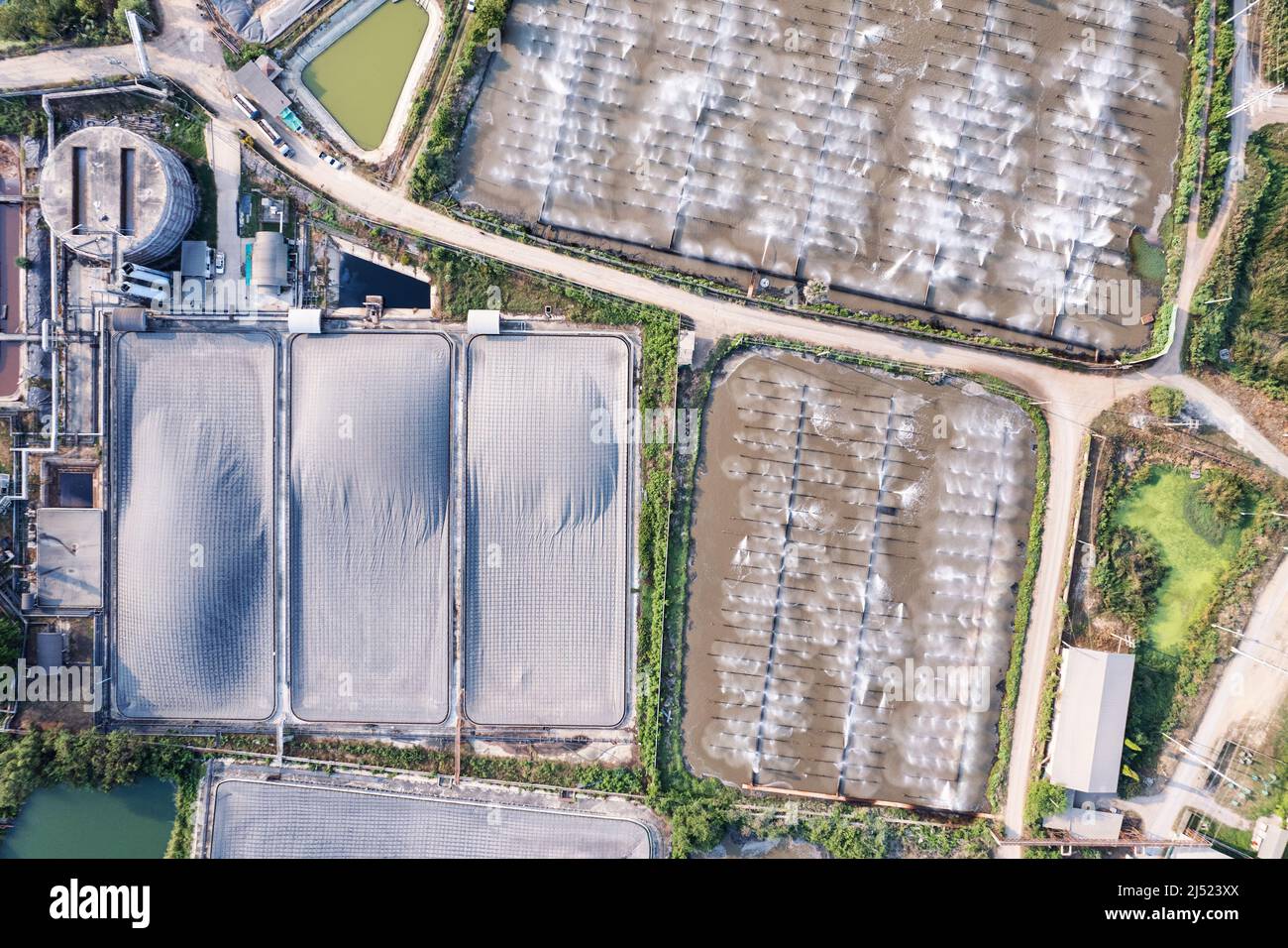 Aerial view of large wastewater treatment pond and plastic covered ...