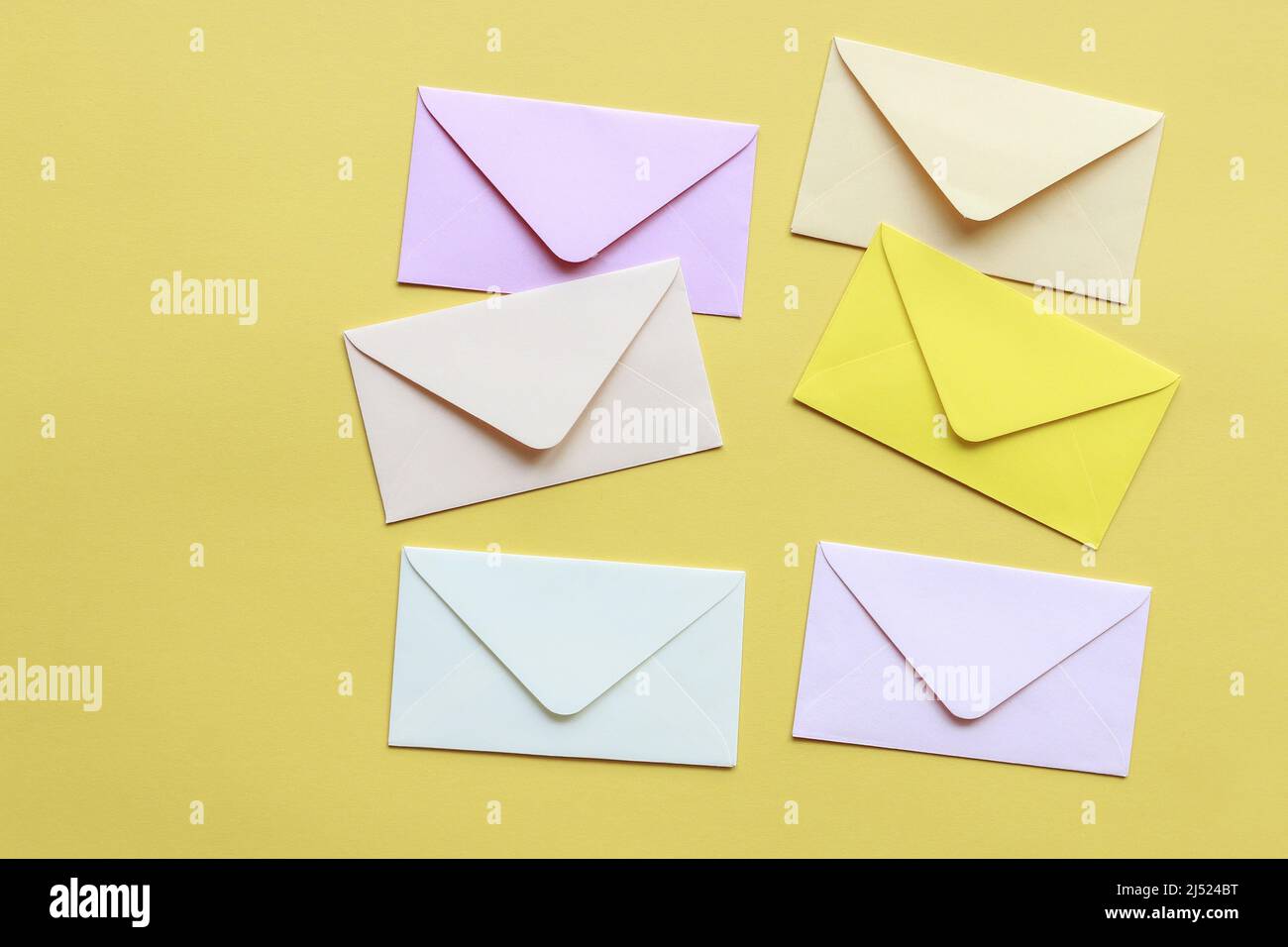 Colorful envelopes on yellow background, copy space Stock Photo - Alamy