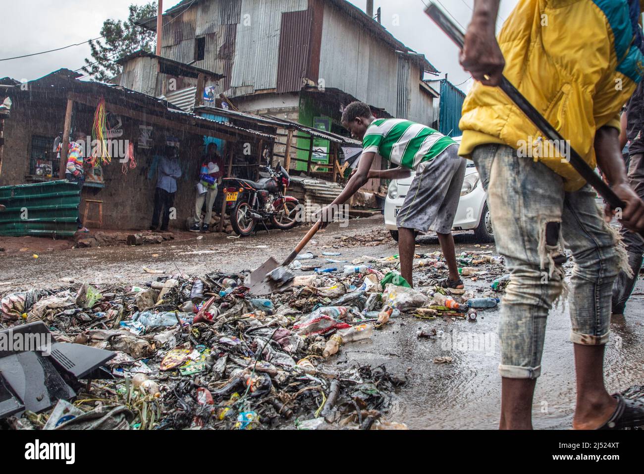 A group of young boys cleaning the road in Kibera on April 18, 2022 ...
