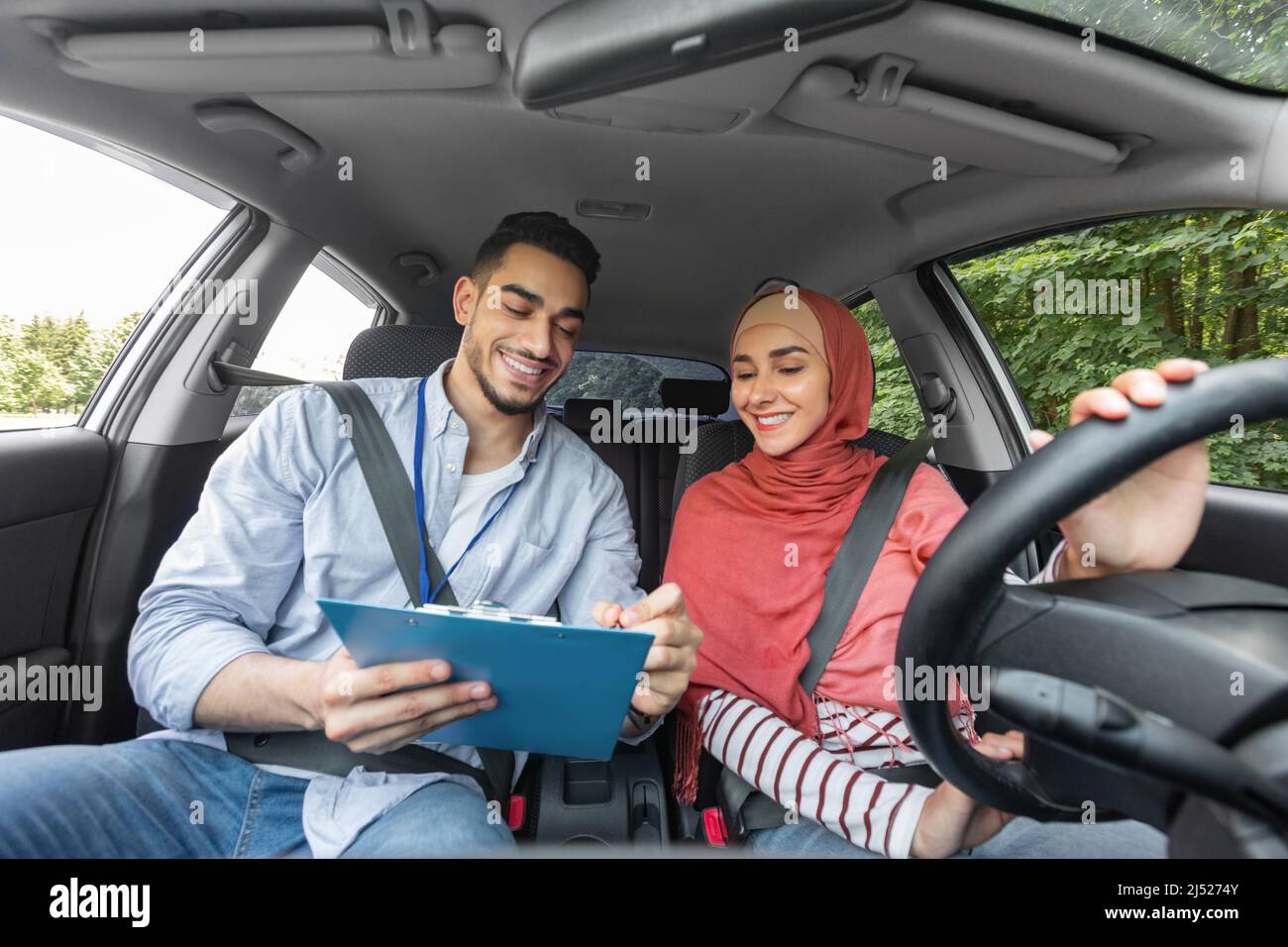 Happy millennial muslim guy instructor gives an excellent mark for exam ...