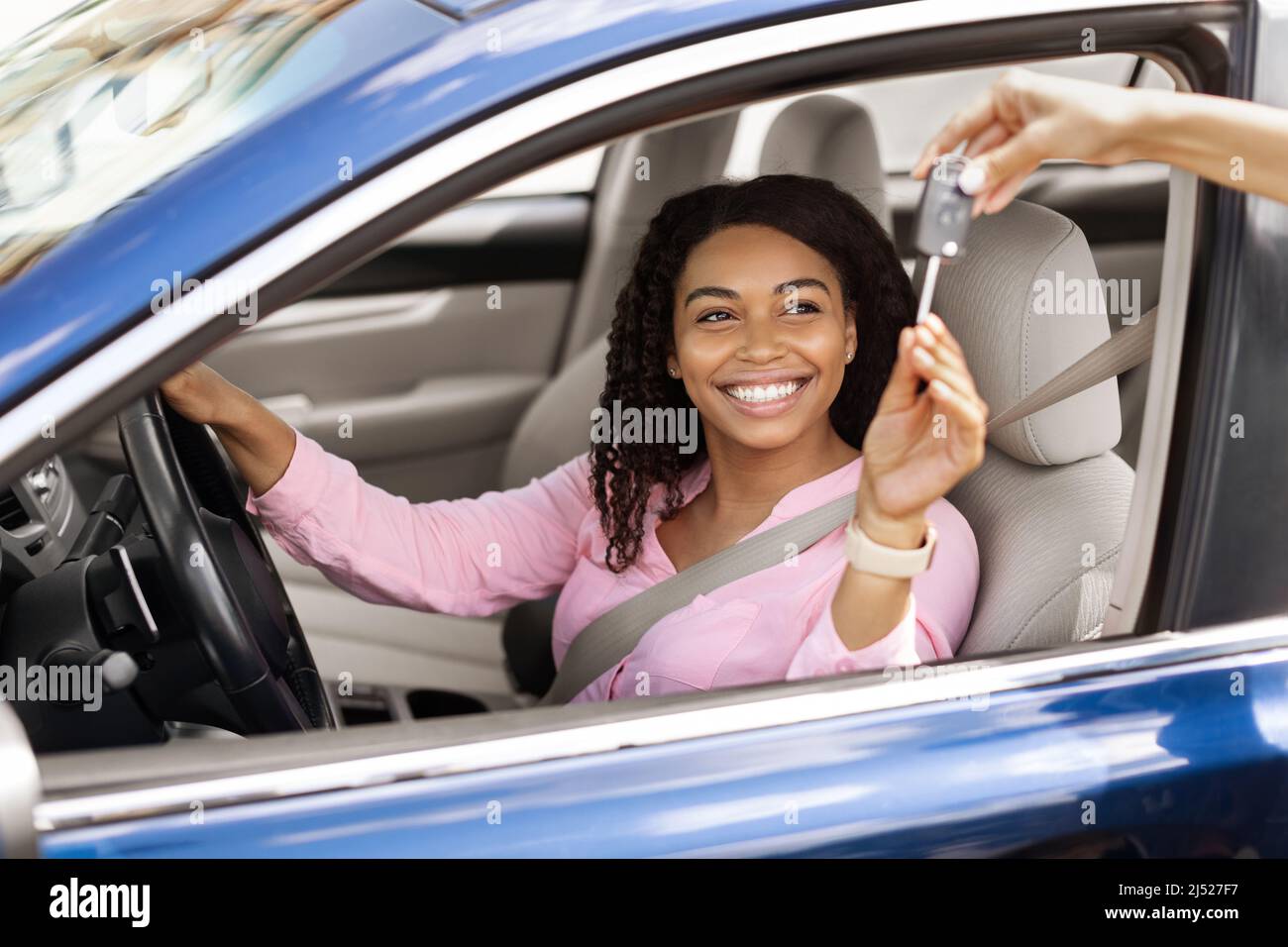 Happy black woman sitting in new car taking keys Stock Photo - Alamy