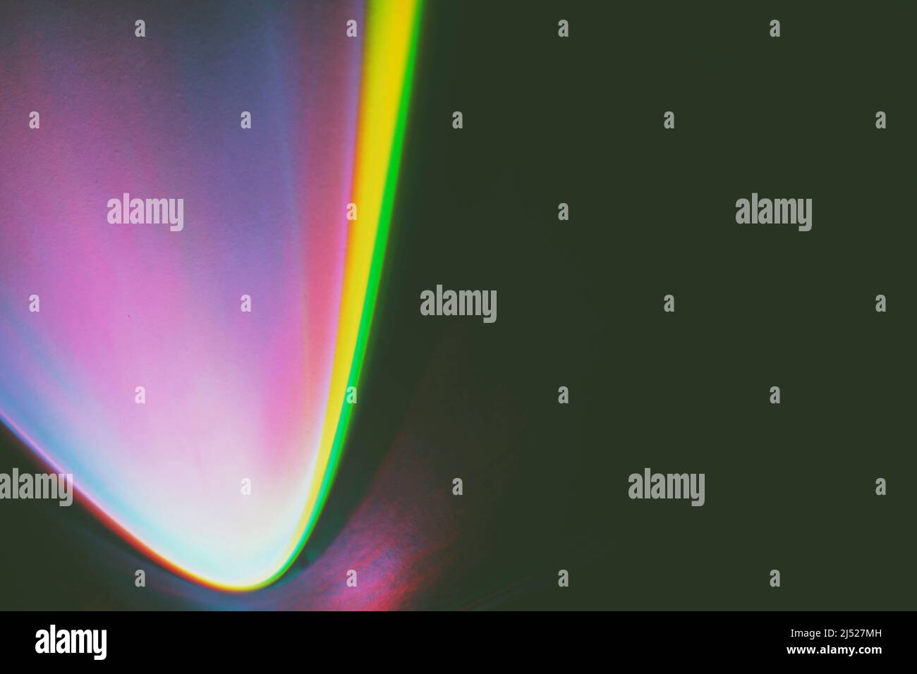 Abstract image of colorful shapes of light against black background ...