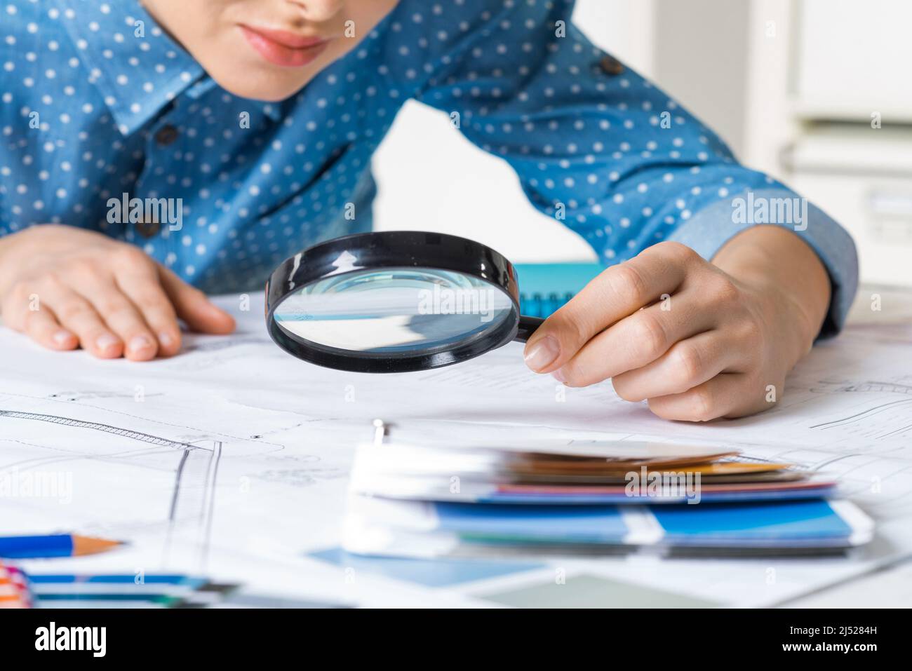 Beautiful woman studying technical drawing Stock Photo - Alamy