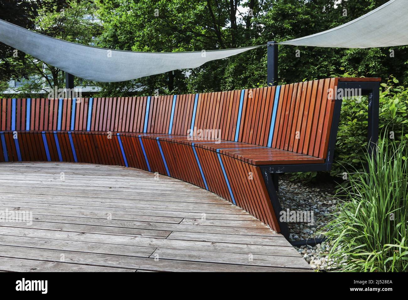Wooden seats in the park, sheltered from the sun by a canopy. Relax ...
