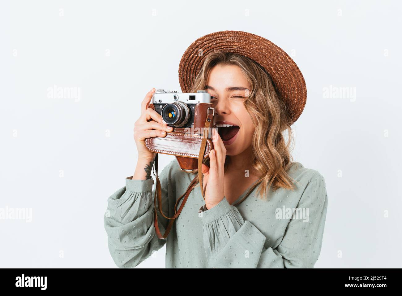 Happy woman photographer looking into camera viewfinder standing on ...