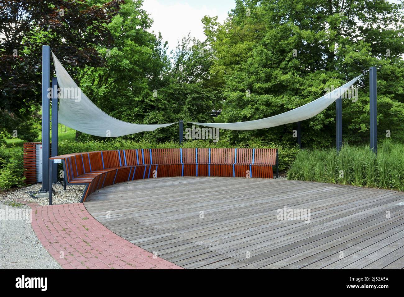 Wooden seats in the park, sheltered from the sun by a canopy. Relax ...