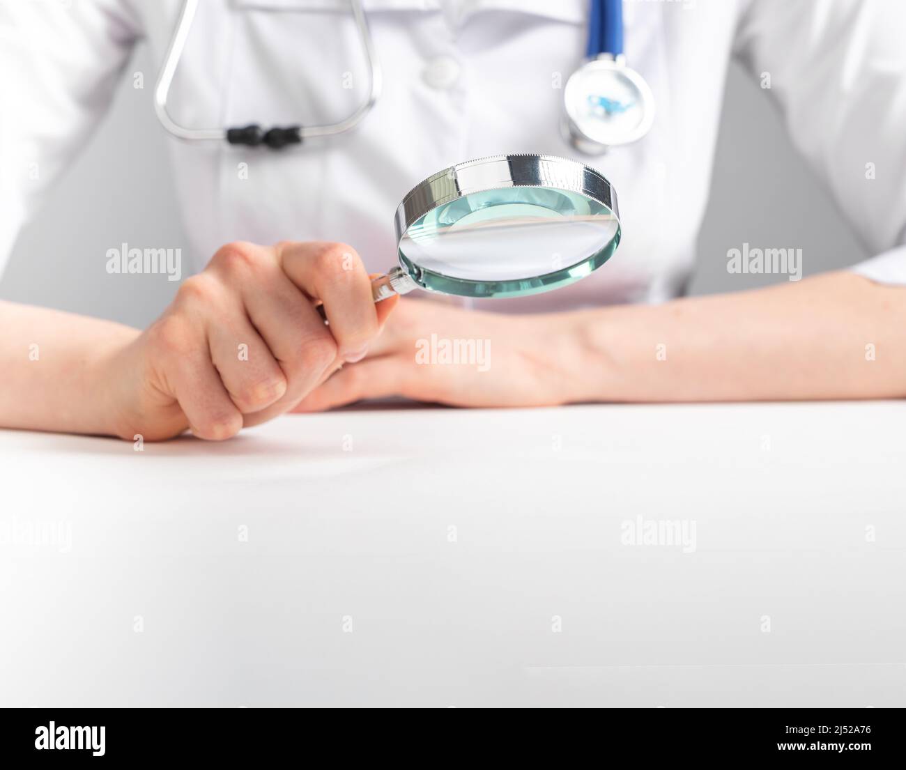 Doctor sitting at table with magnifier. Medical checkup, thorough ...