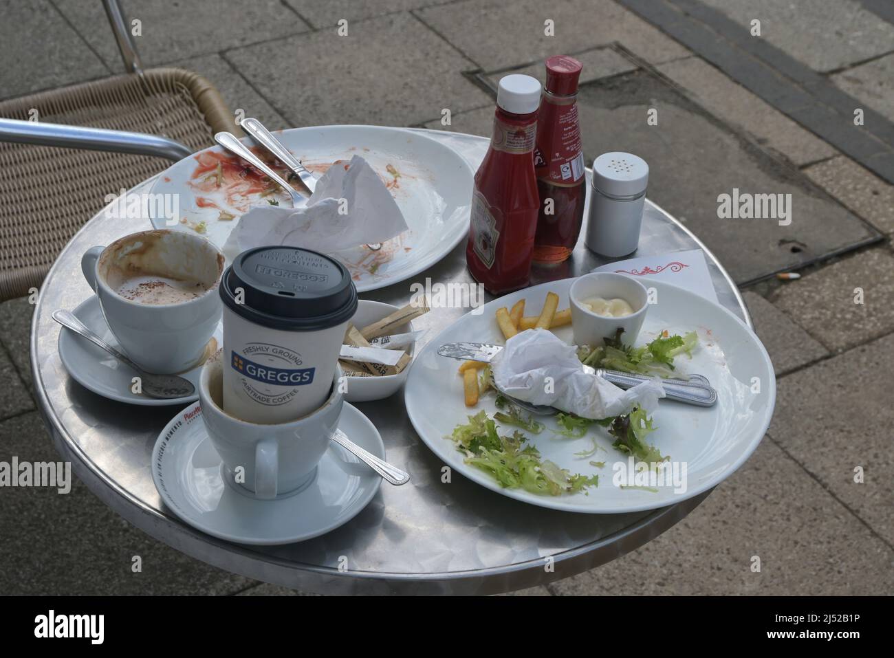 table of dirty plates and cups outside a cafe, england Stock Photo - Alamy