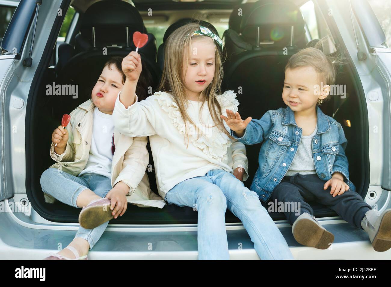 Cute little kids sitting in a car's trunk before a road trip Stock ...