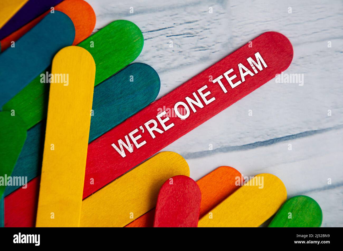 We're one team text on red wooden stick. Teamwork concept Stock Photo ...