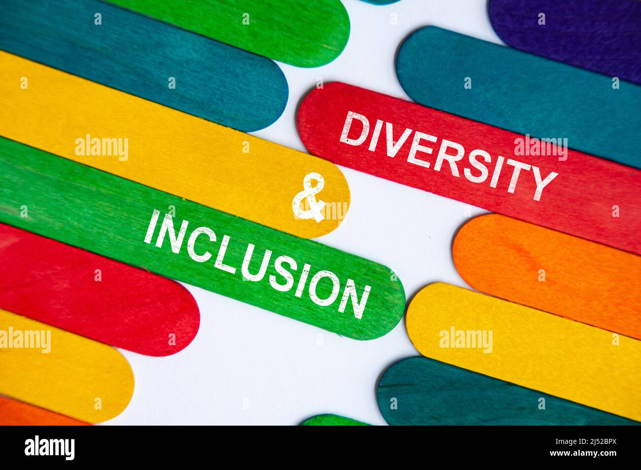 Diversity and inclusion text on colorful wooden stick - business ...