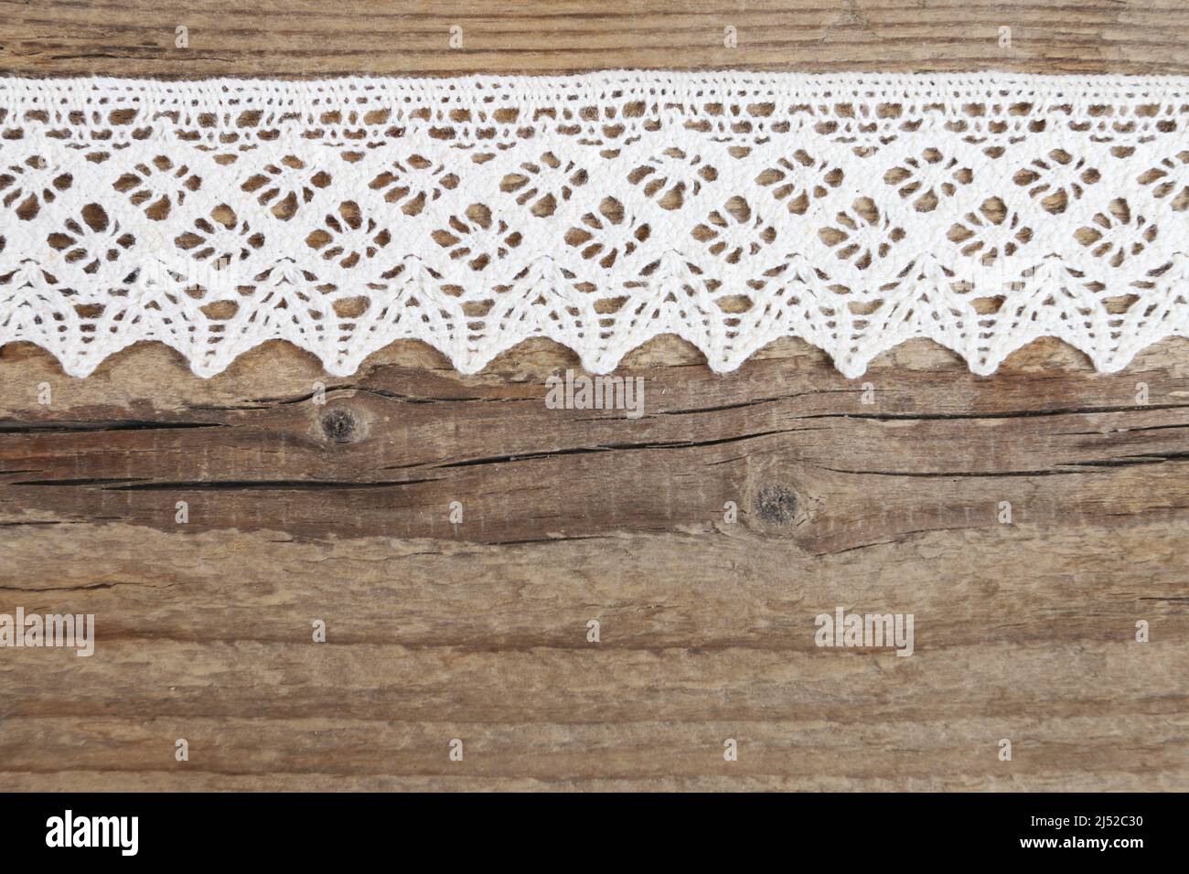 Traditional lace on rough wooden background, copy space. Graphic ...
