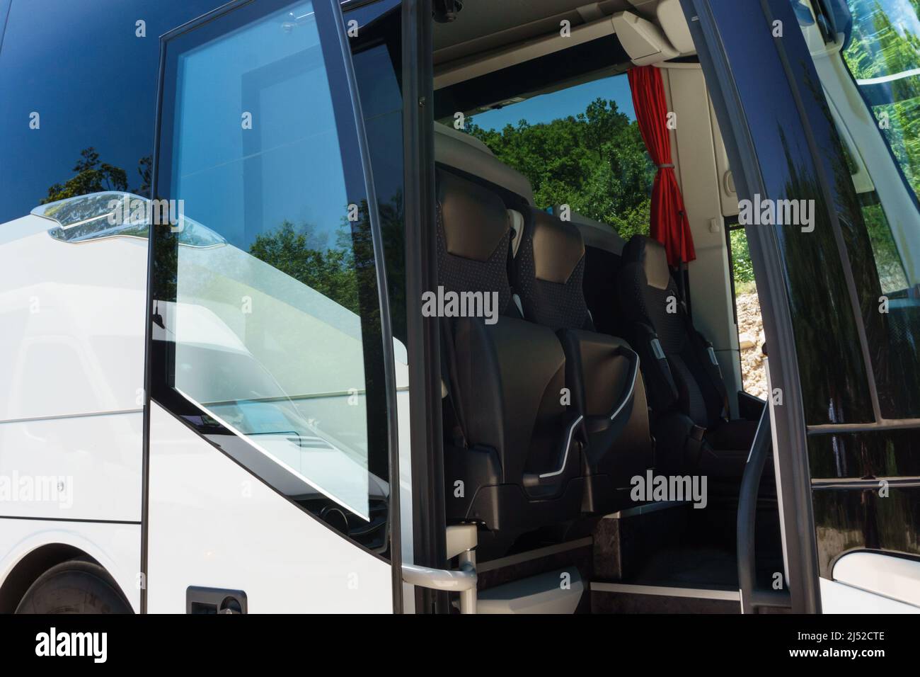 Modern buses for transporting people stand at the bus stop. Close-up of ...