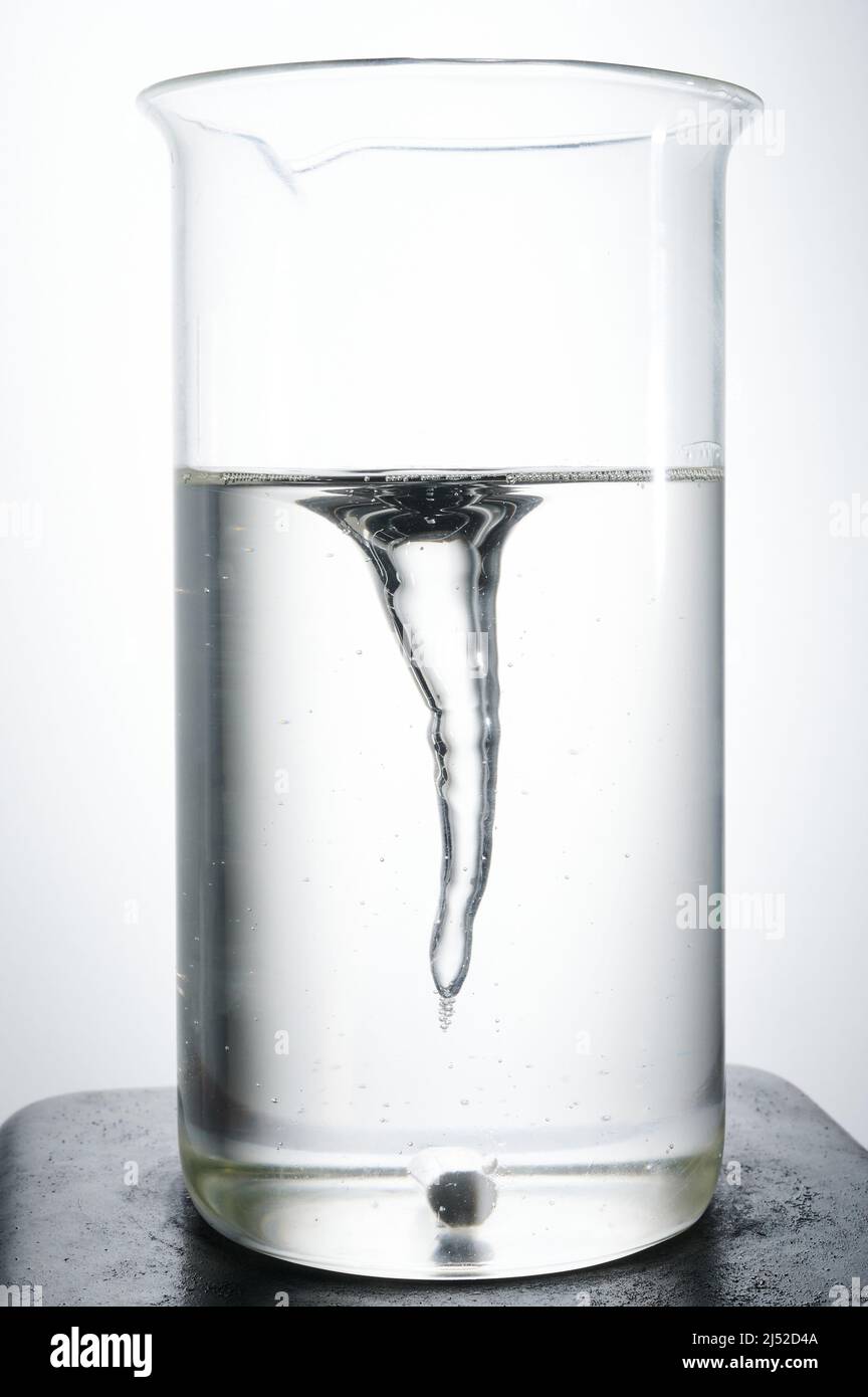 Swirl of liquid wax in glass flask isolated on white background Stock ...