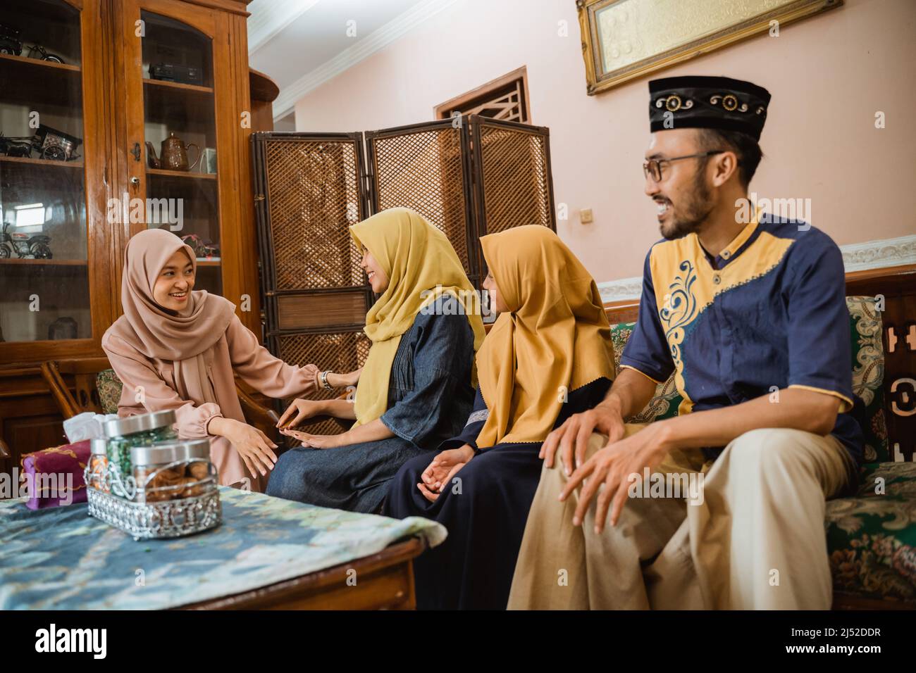 family visiting friend and having conversation during idul fitri family ...