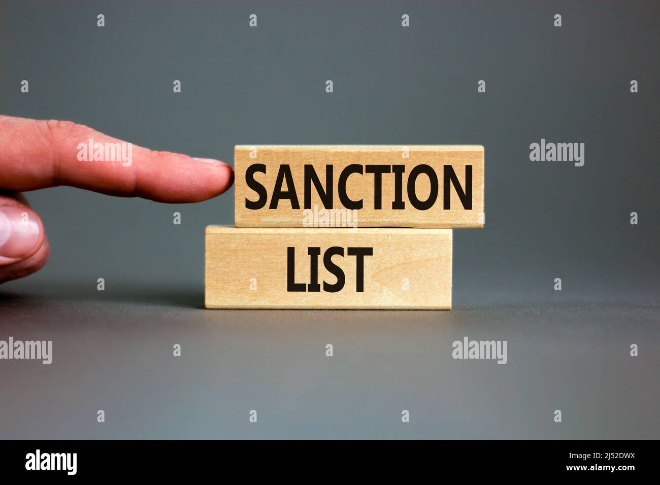 Sanction list symbol. Wooden blocks with concept words Sanction list on ...