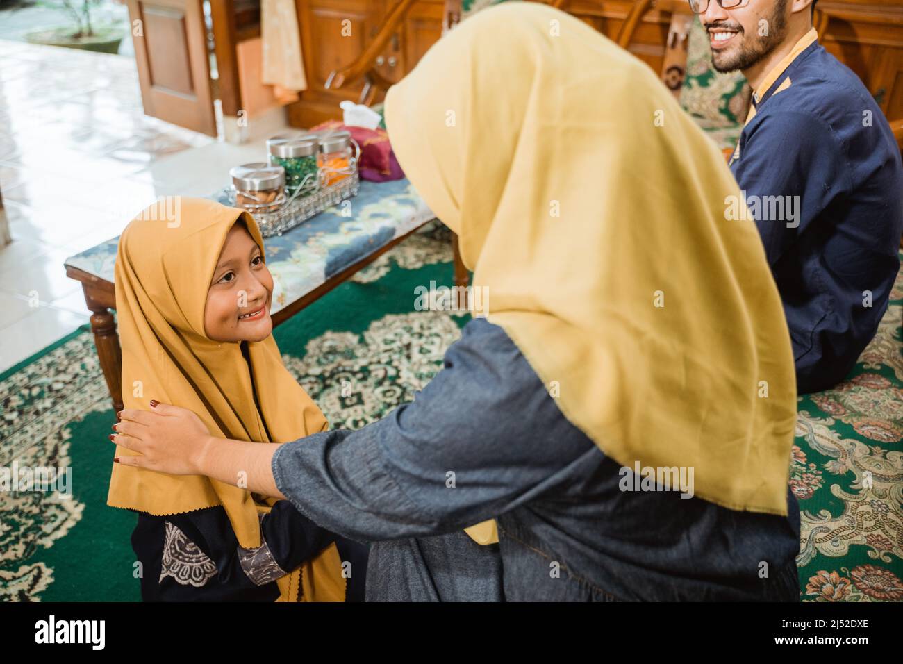 muslim family shake and kissing hand during idul fitri Stock Photo - Alamy