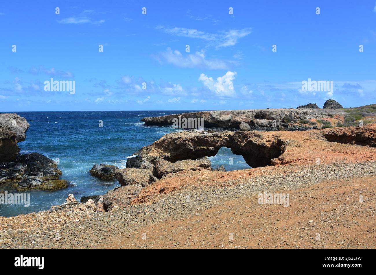 Rugged lava rock natural bridge on the coast of Aruba Stock Photo - Alamy