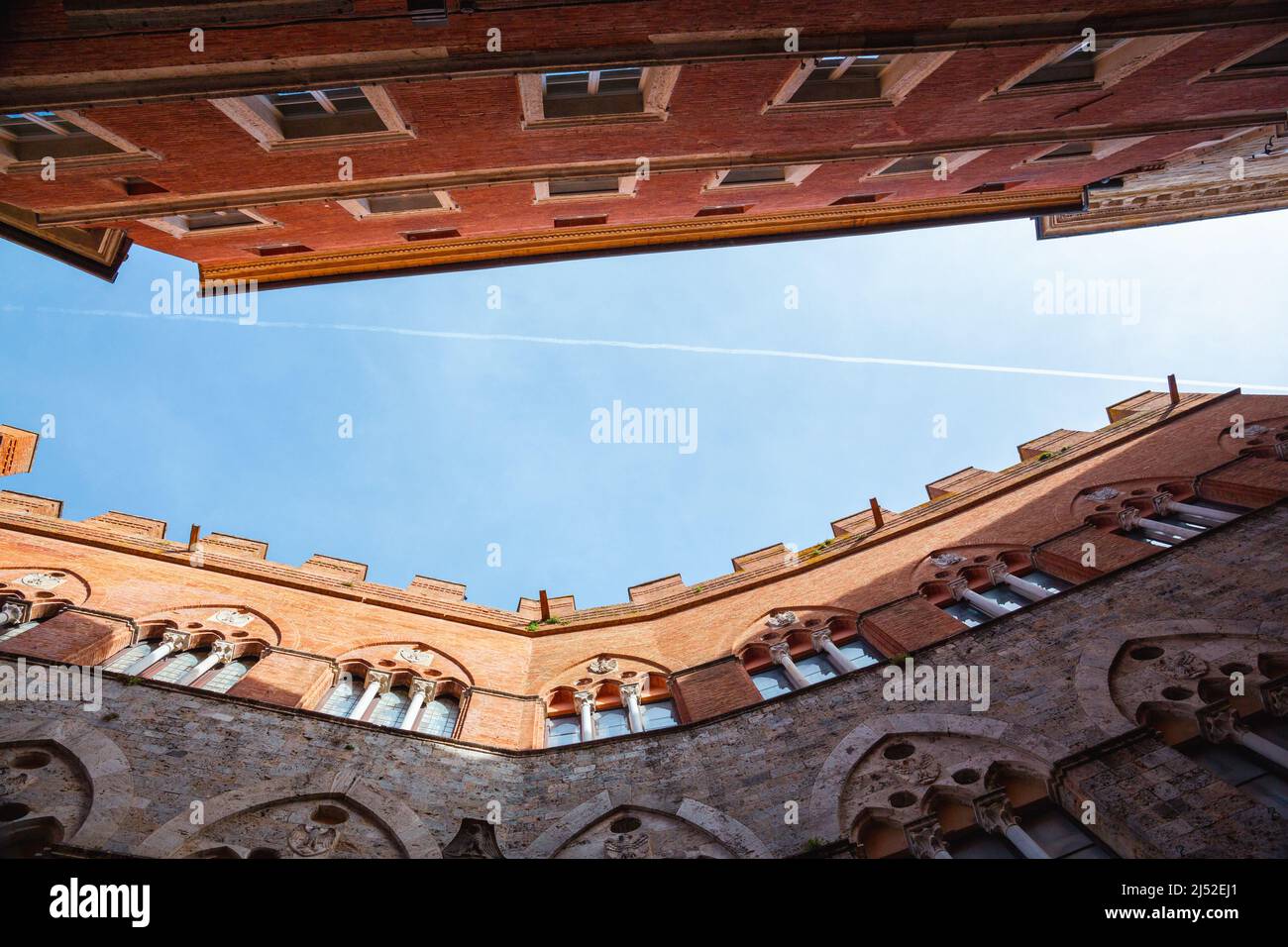 Brick facade buildings with battlements along an ancient medieval ...