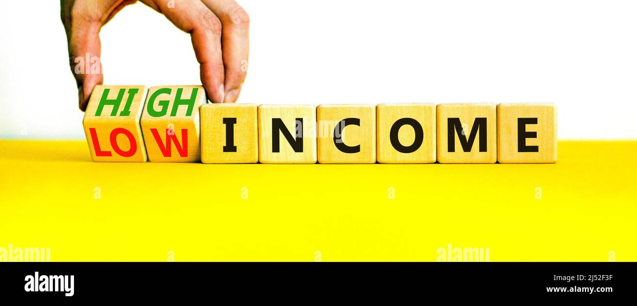 Low or high income symbol. Businessman turns wooden cubes and changes ...