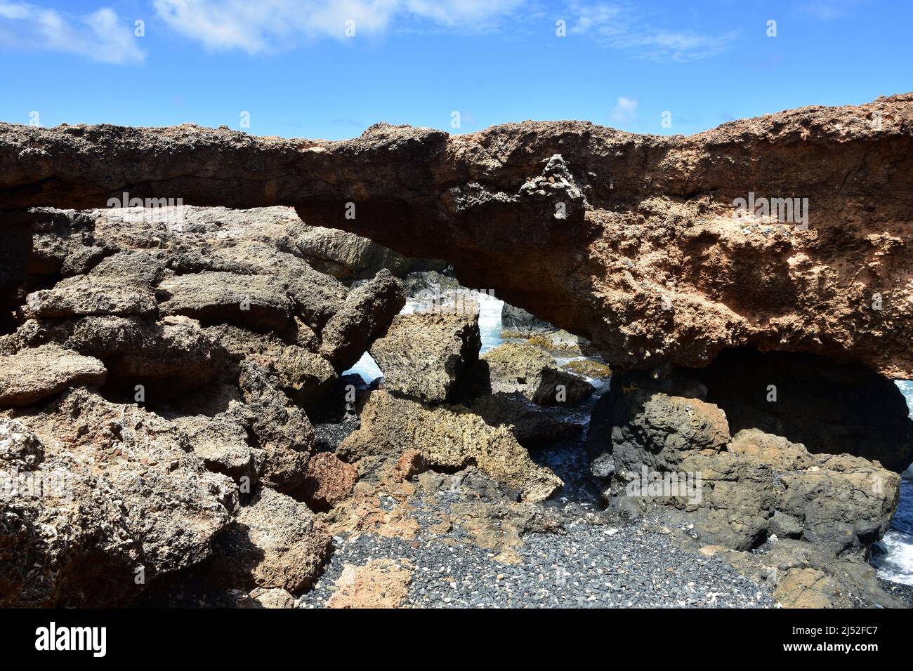 Scenic natural arched rock bridge on the coastline of Aruba Stock Photo ...
