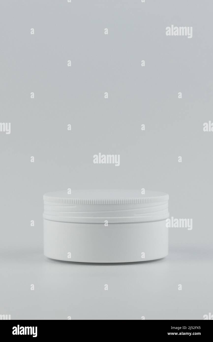 Unbranded white plastic jar for cosmetics products vertical mockup ...