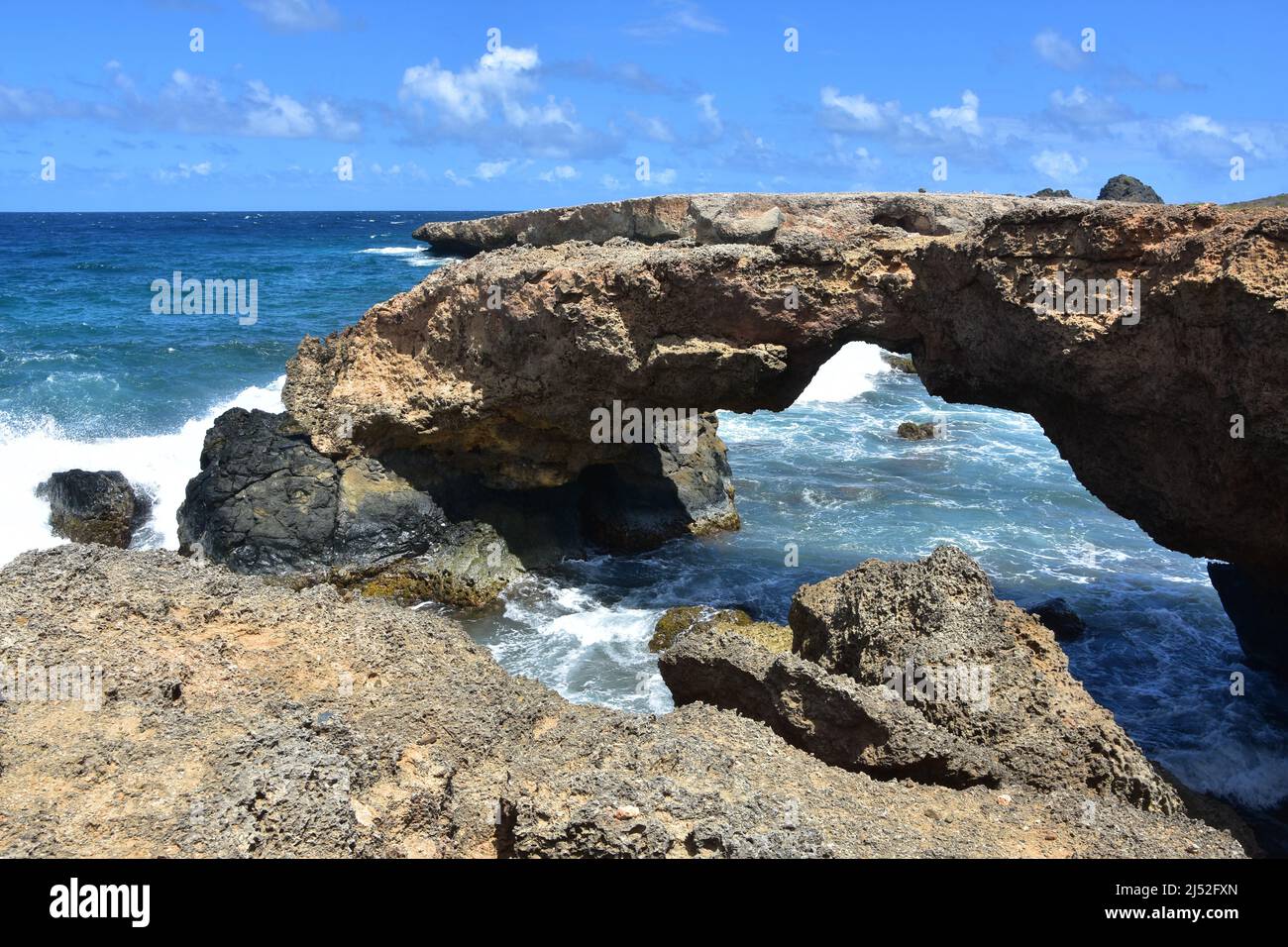 Stunning natural arched lava rock bridge along the coast of Aruba Stock ...