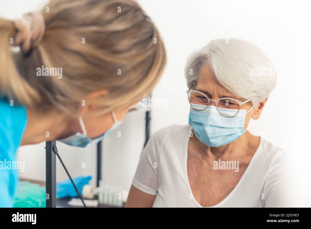 female doctor giving advice to her senior woman patient medium closeup ...