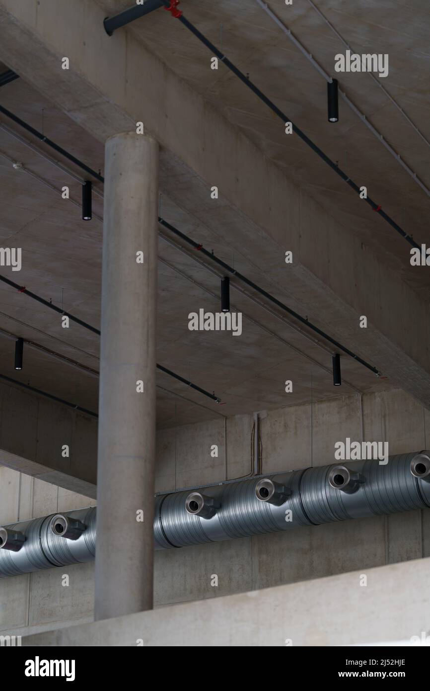 A high industrial room with columns, lighting and a fire protection ...