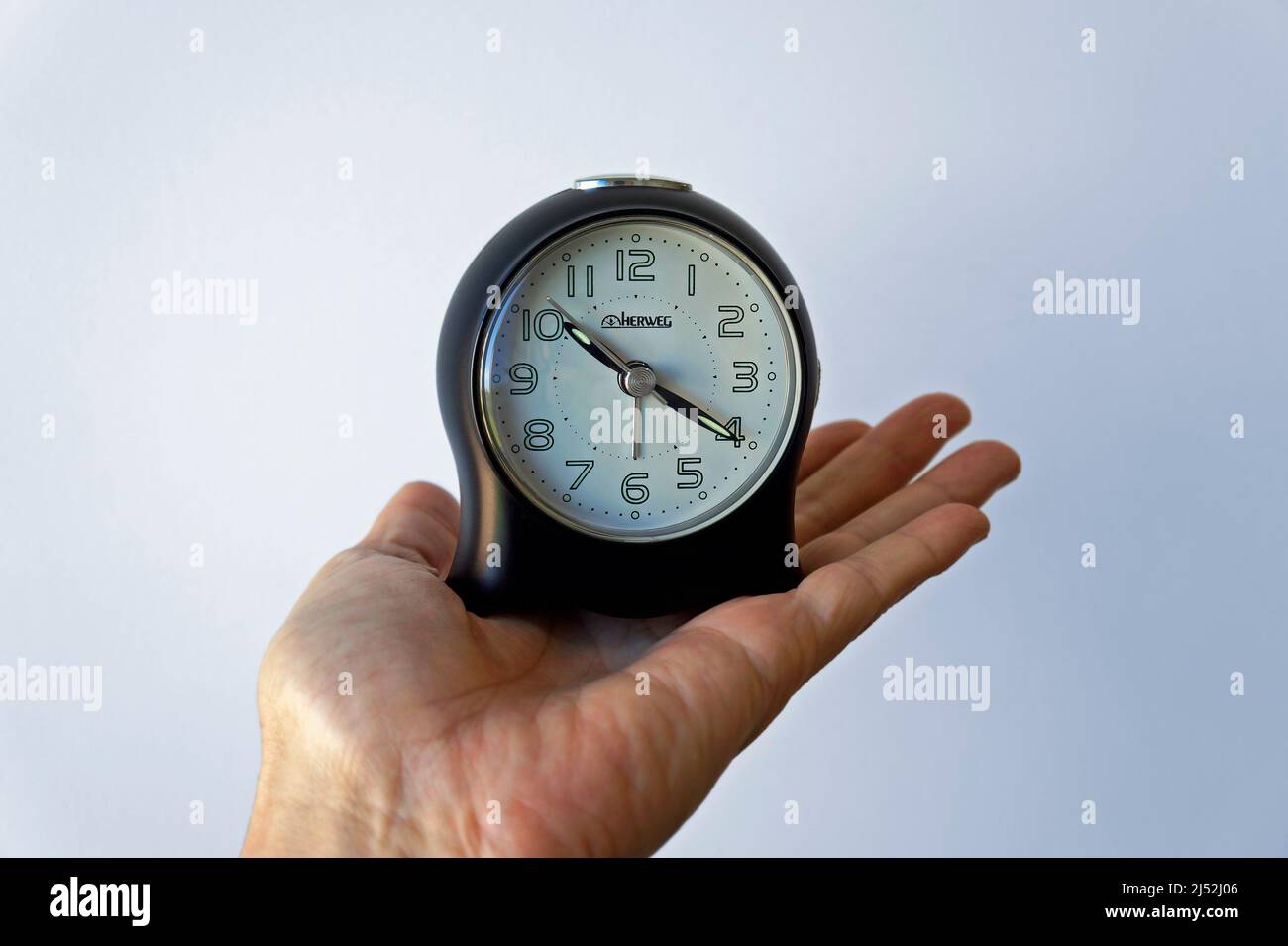 Hand on alarm clock hi-res stock photography and images - Alamy