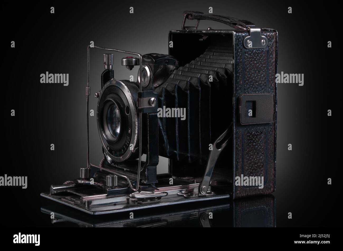 retro folded analog camera on black background with reflection Stock ...