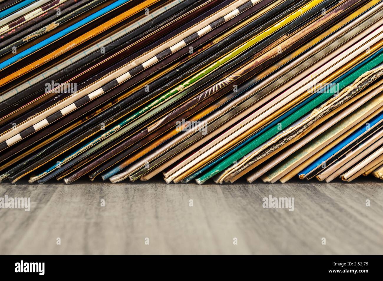 pile of old vinyl discs on wooden background Stock Photo - Alamy