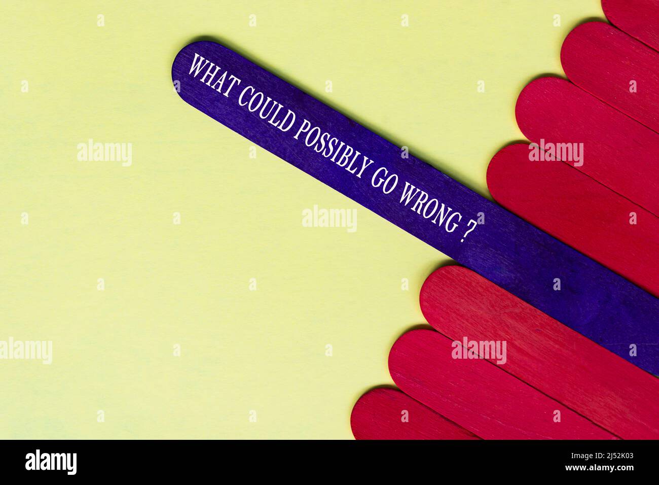 What could possibly go wrong question text on purple color wooden stick ...