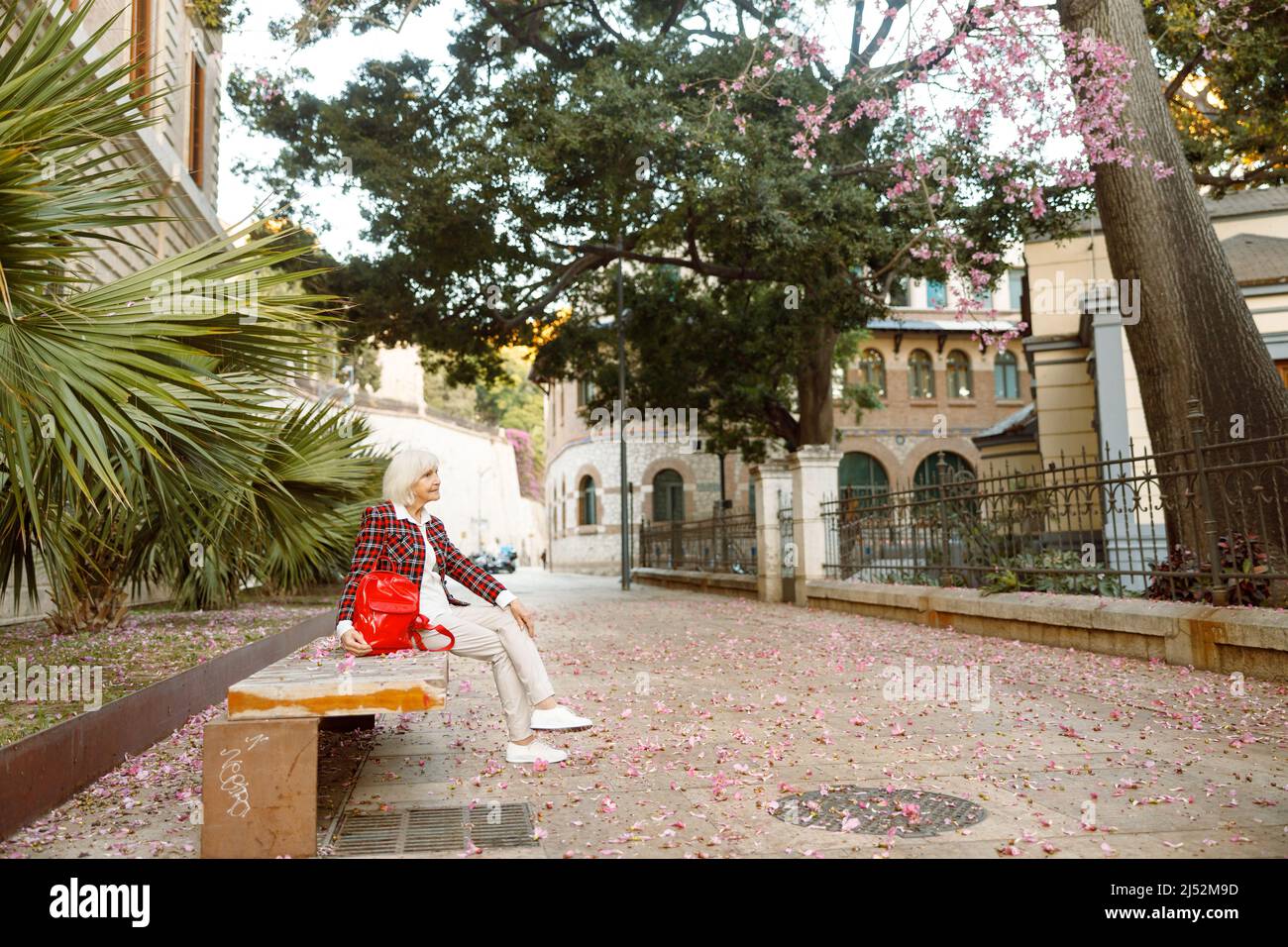 Beautiful senior woman thinking outdoors in town Stock Photo - Alamy