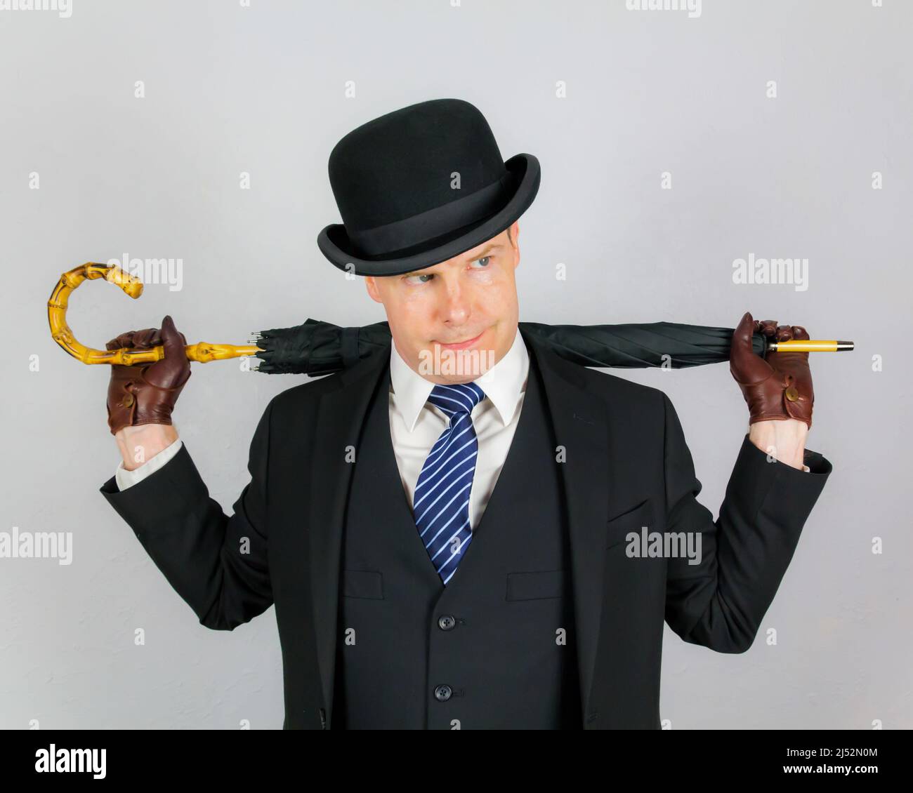 Portrait of British Gentleman in Dark Suit and Bowler Hat Holding ...