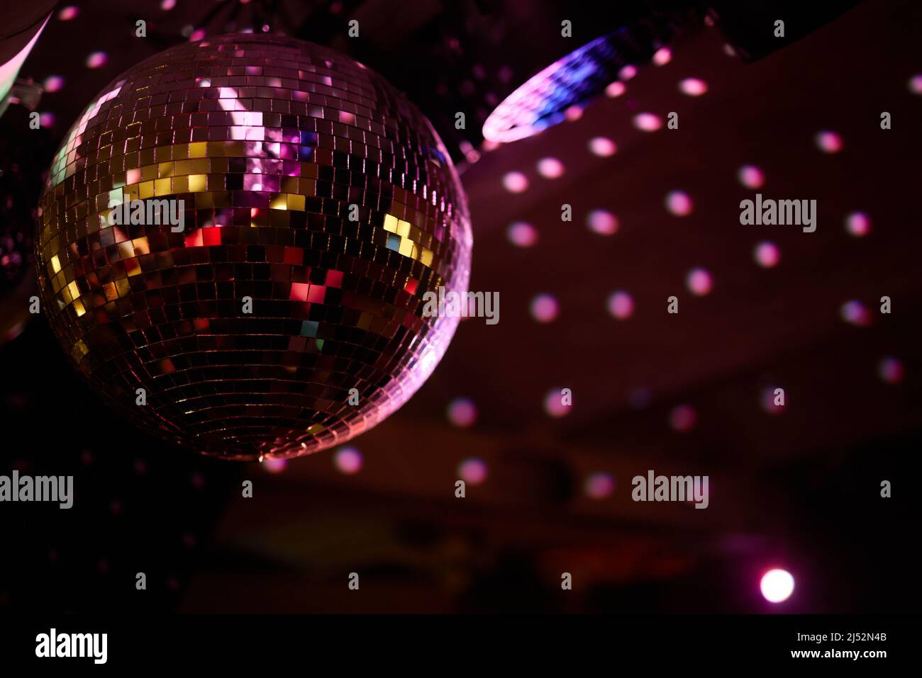 Colorful disco mirror ball lights night club background Stock Photo - Alamy