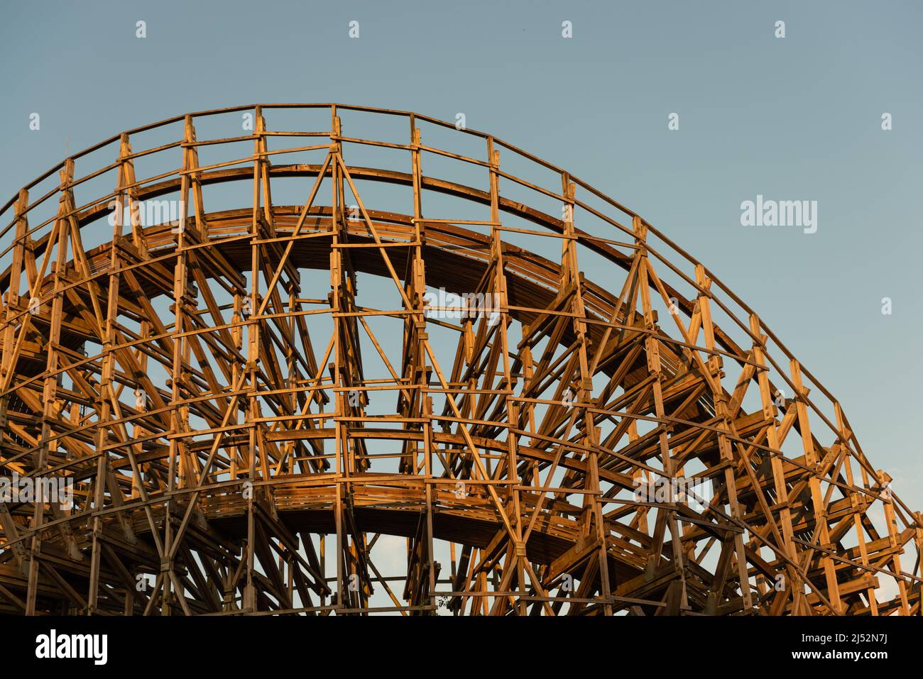 Curve of a large wooden roller coaster Stock Photo - Alamy