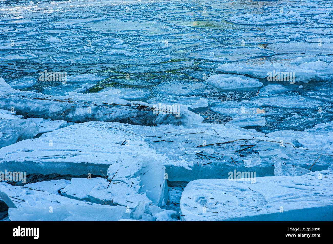 Blue ice flakes in a river Stock Photo - Alamy