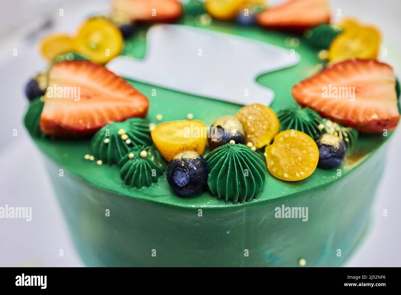 Modern French mousse cake with green mirror glaze. Picture for a menu ...