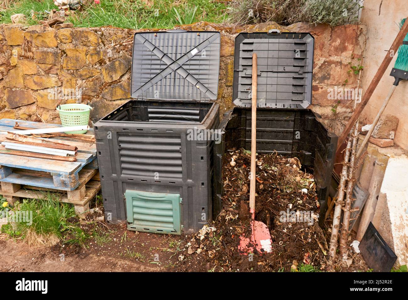 Garden shovel on compost. Freshly composted earth from compost bin ...