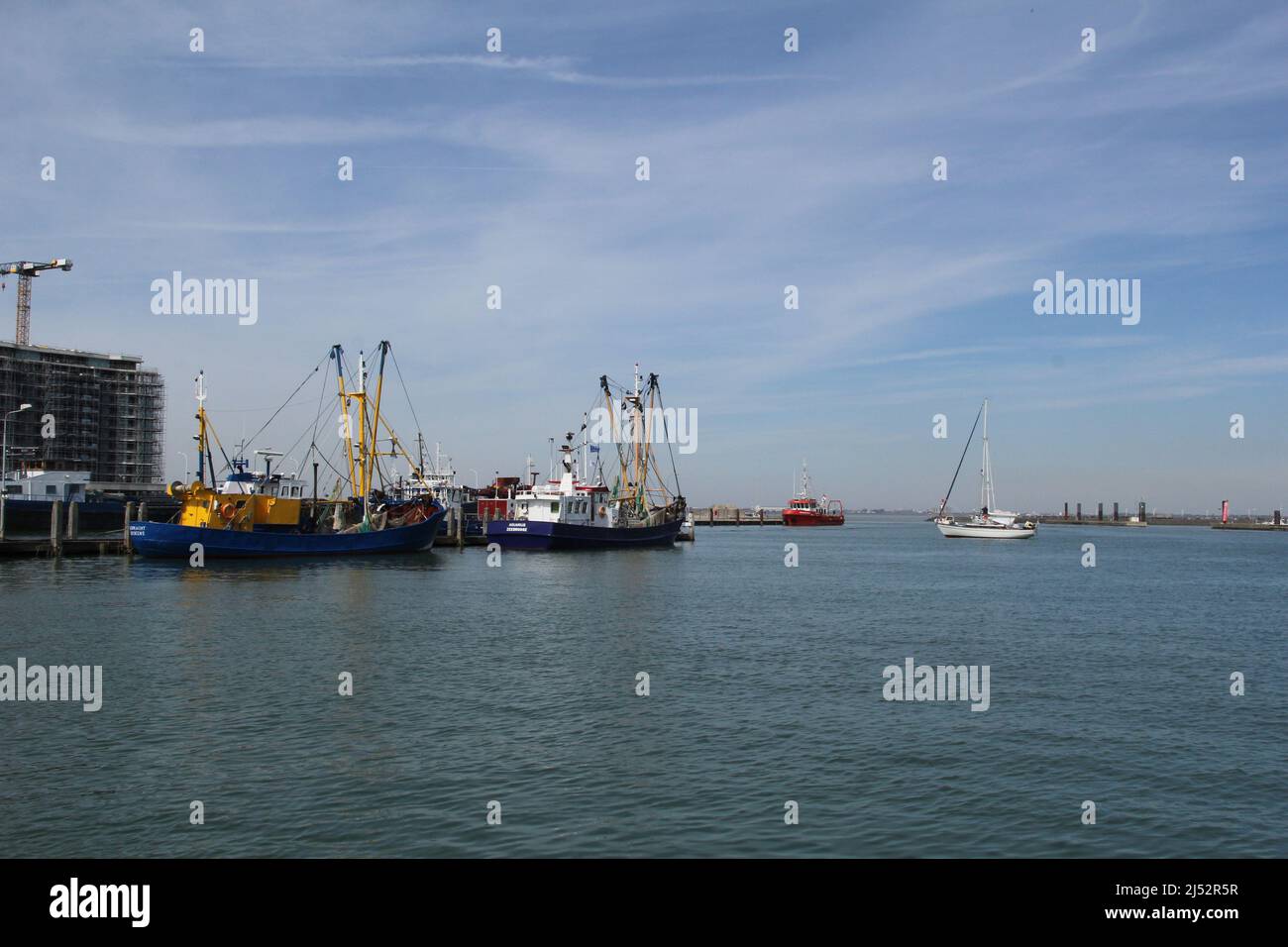 the fishing port of breskens at the dutch coast with two fishing boats ...